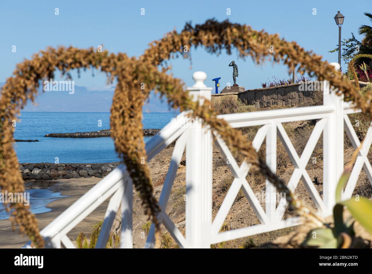 Statue of Javier Perez Ramos at the viewpoint overlooking Playa del Duque beach, Costa Adeje ...