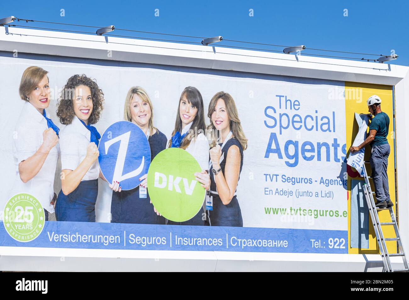 Putting up a billboard advertising insurance agency in Costa Adeje ...