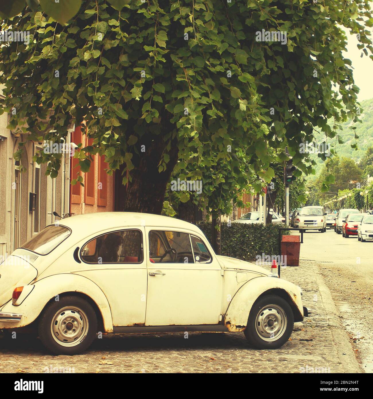 Old-fashioned retro small car parked on the street of european town ...