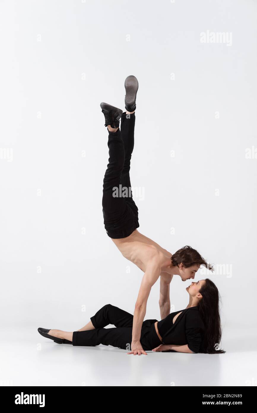 Young and graceful ballet dancers in minimal black style isolated on ...