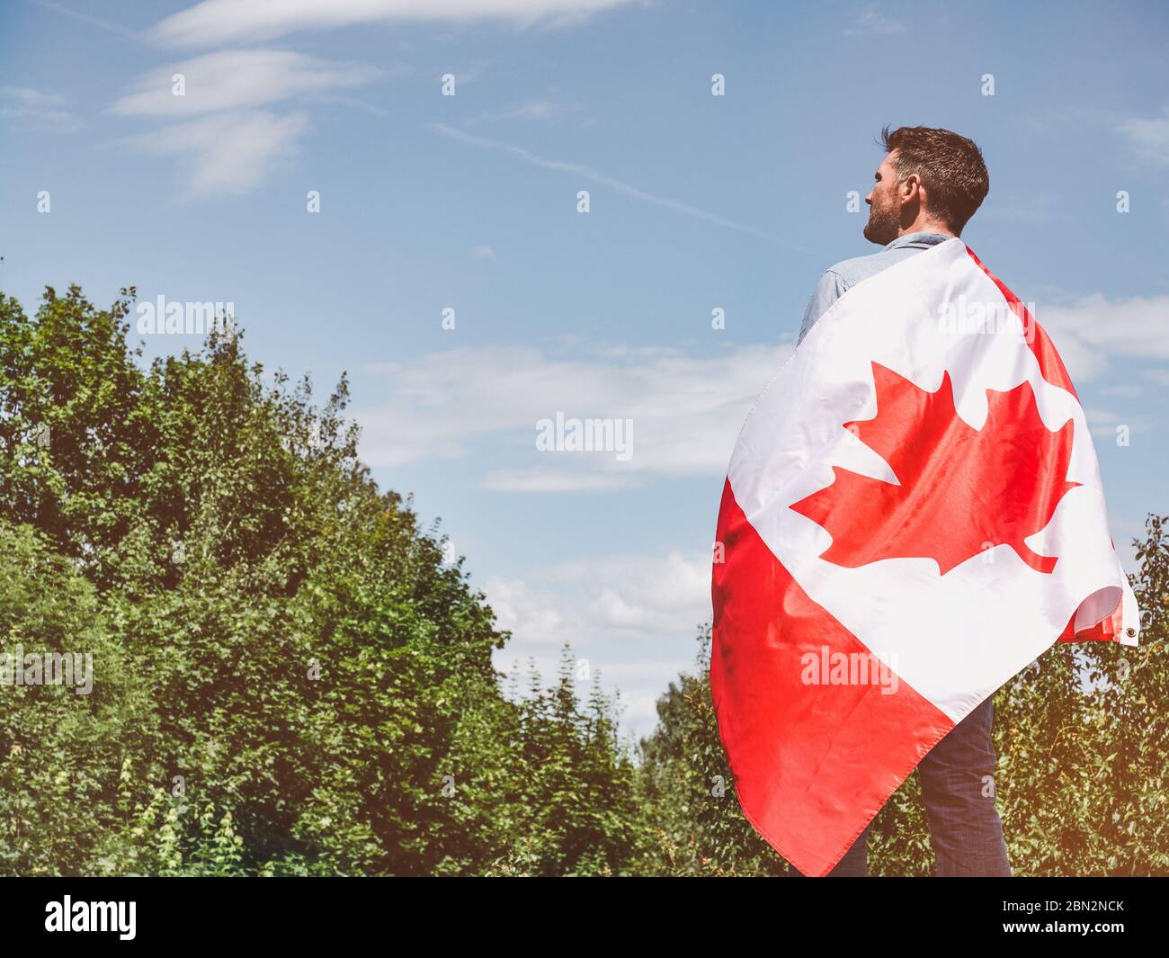 Attractive man holding Canadian Flag. National holiday Stock Photo - Alamy