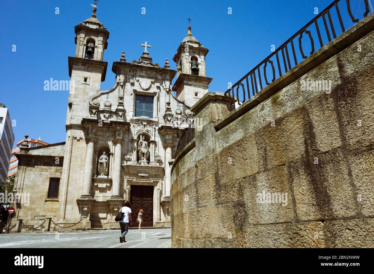 Coruña, Spain : People walk past the facade of St. George Church ...