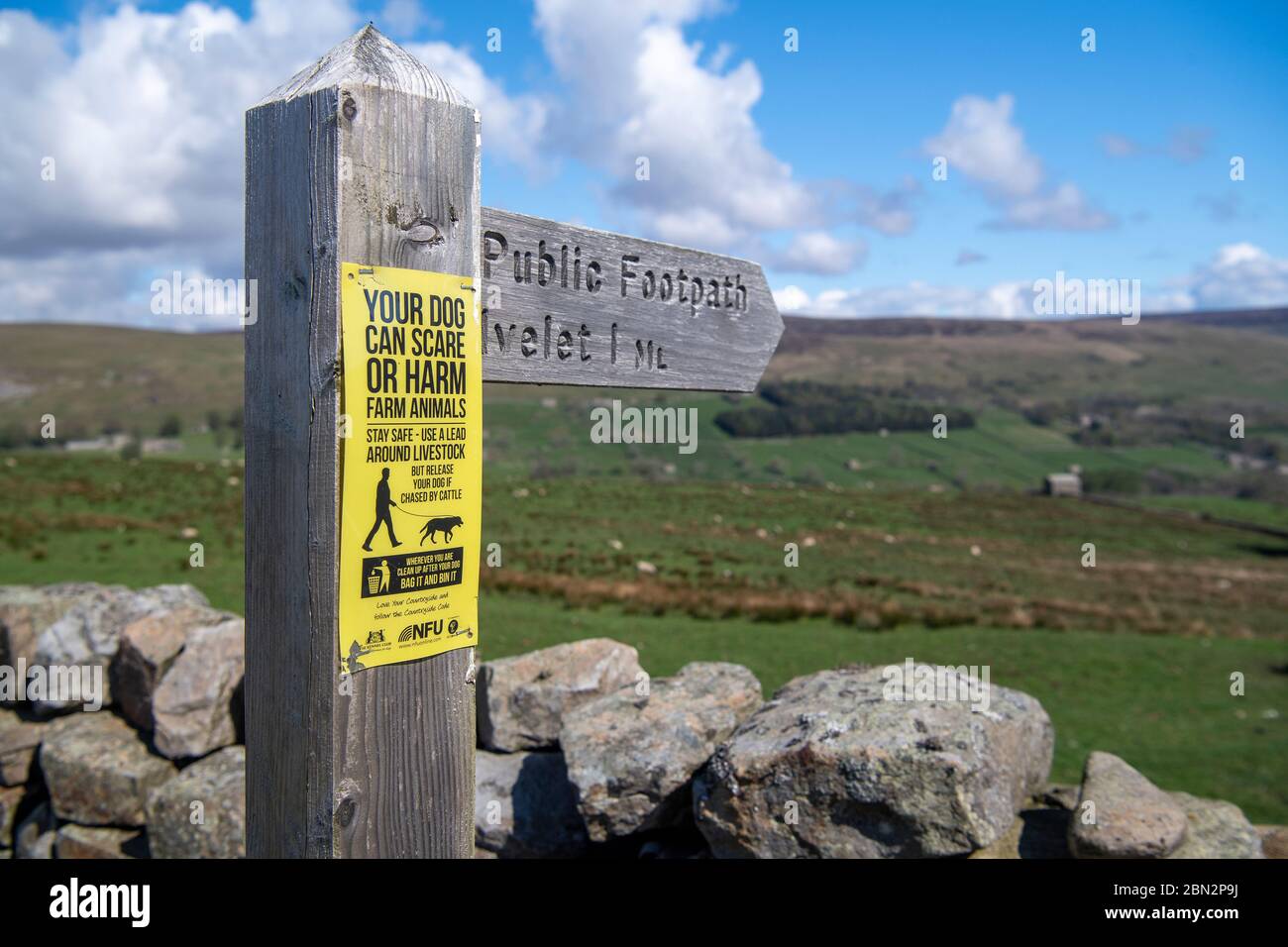 Sign on a Public Footpath signpost, warning against allowing dogs of ...