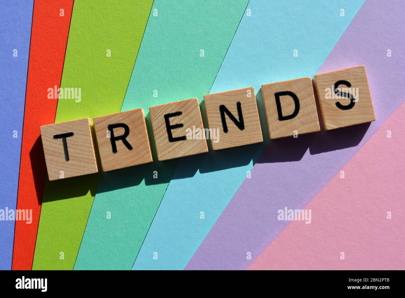 Trends, word in wooden block letters on multicoloured background Stock ...