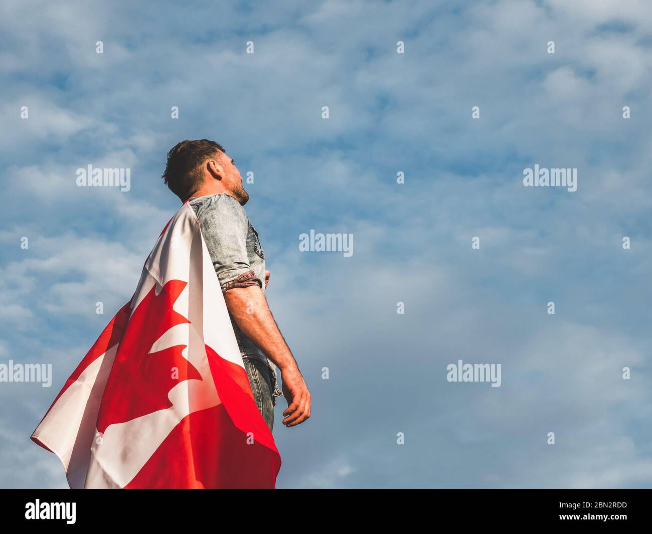 Attractive man holding Canadian Flag. National holiday Stock Photo - Alamy