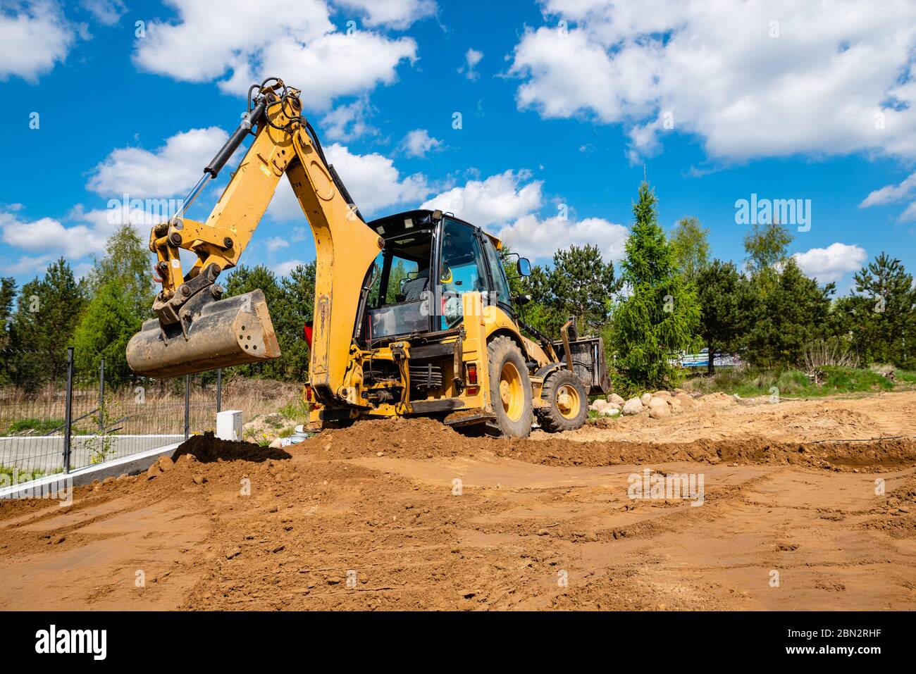 Excavator at work on construction site Stock Photo - Alamy