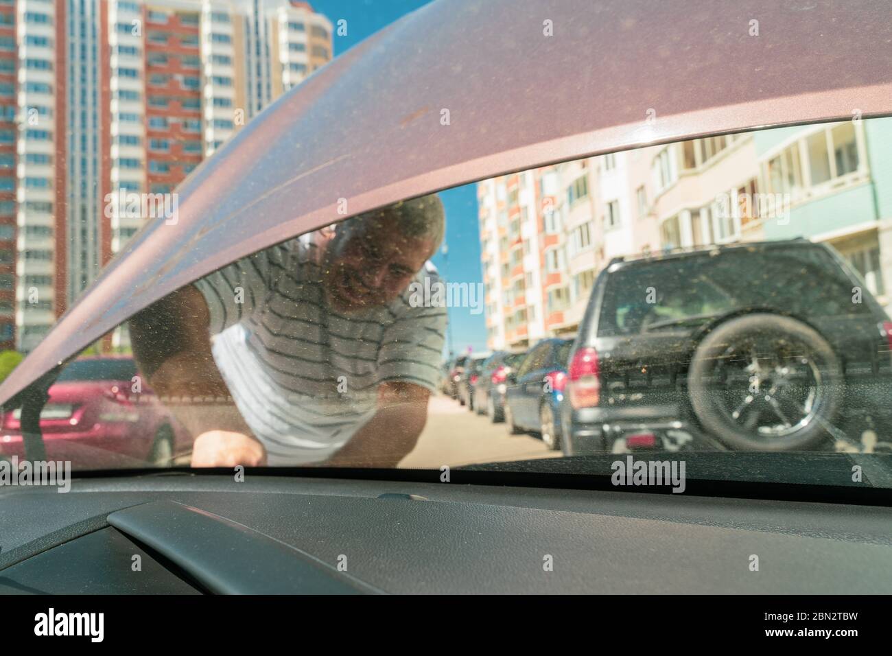 Mechanic examining under hood car hi-res stock photography and images ...
