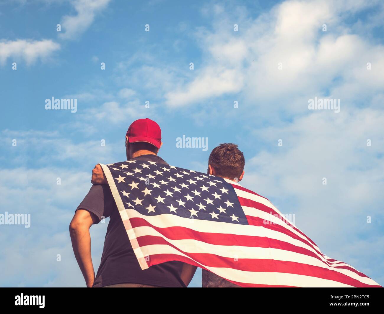 Two men holding Flag of the United States Stock Photo - Alamy
