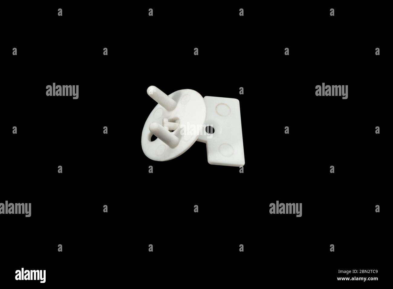 plastic lock for child protection sockets isolated on black background ...