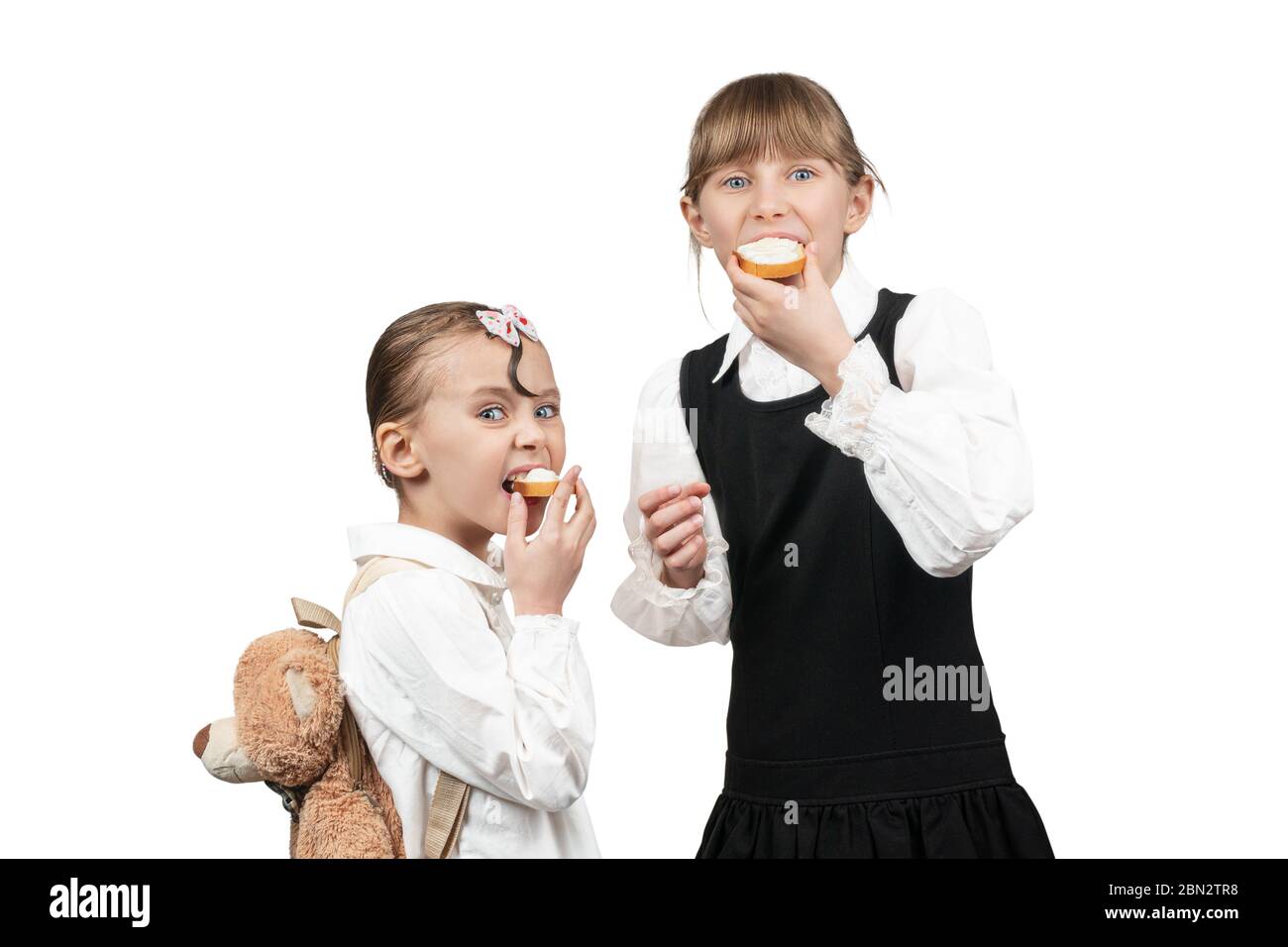 Children bite bread with sour cream isolated on a white background ...