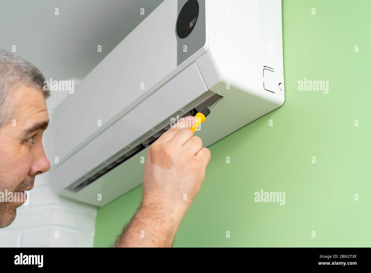 Male technician repairing and diagnosing air conditioners. Diagnostics ...