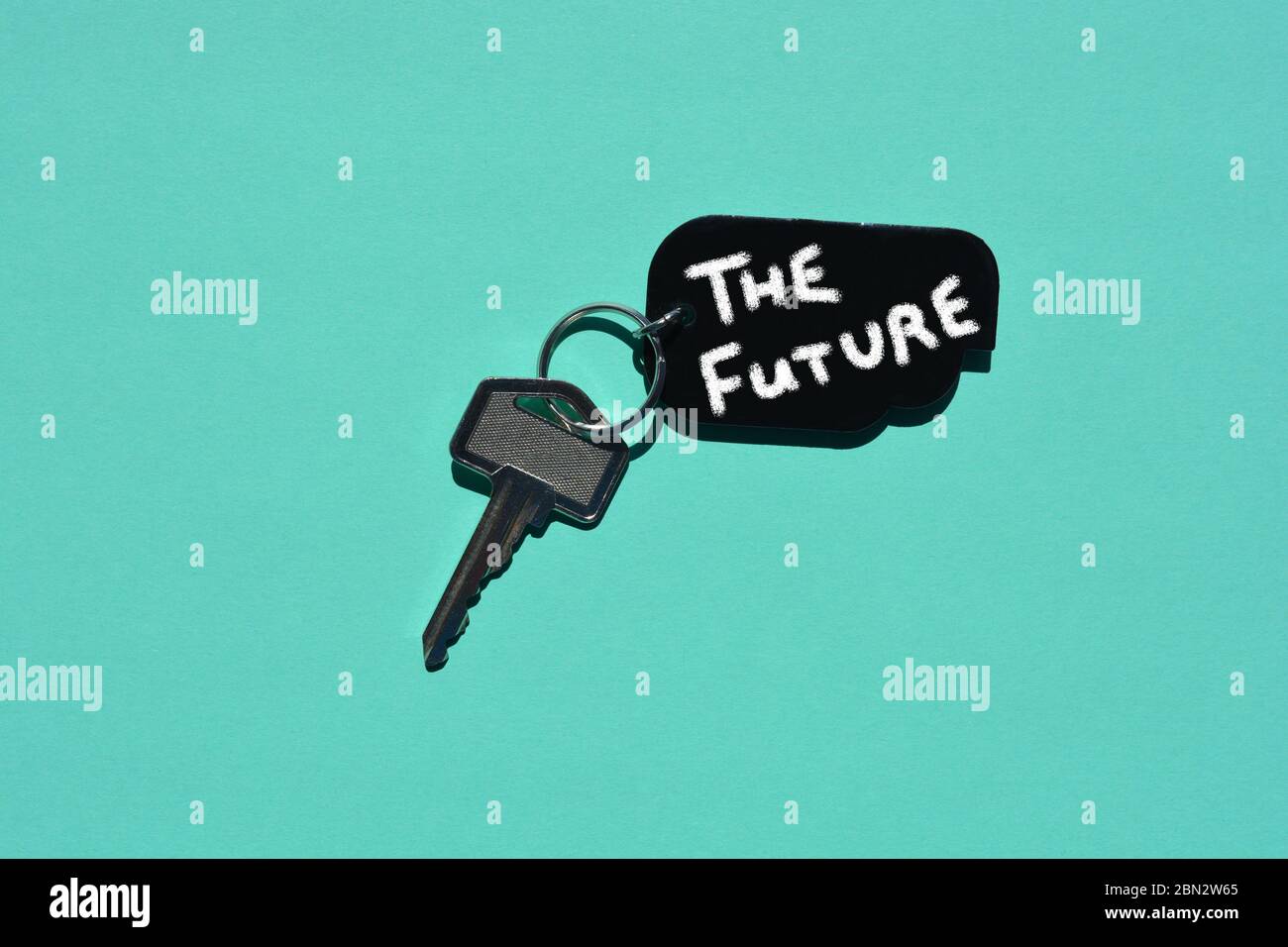 Key and tag with the words The Future, isolated on turquoise background ...