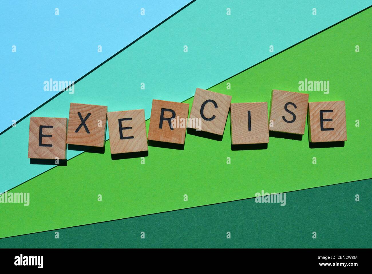 Exercise, word in 3d wood alphabet letters on green background Stock ...