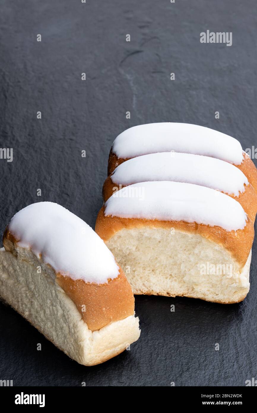 Iced finger buns on black stone background Stock Photo - Alamy