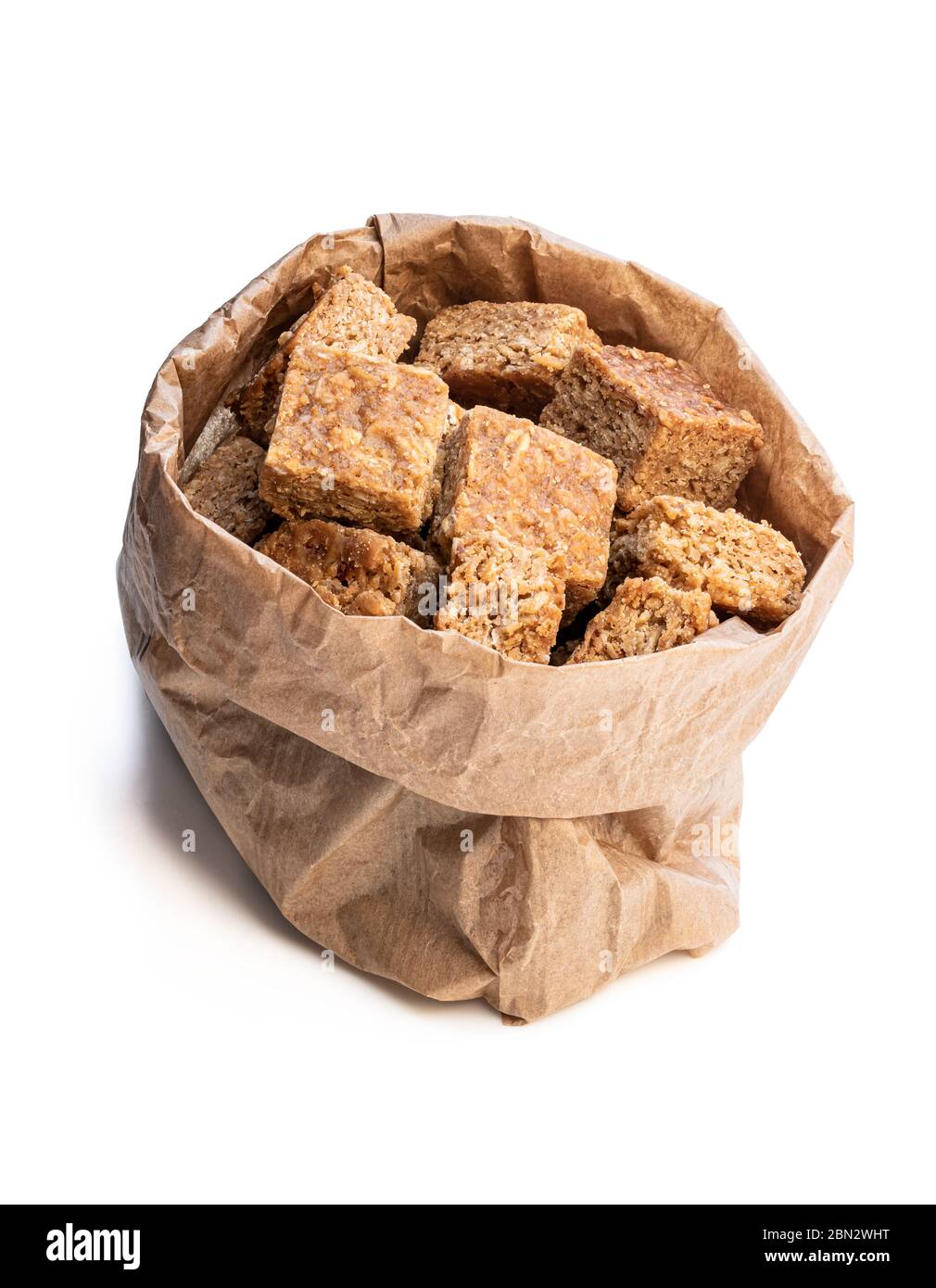 Mini oat and syrup flapjack slices in paper bag isolated on white Stock ...