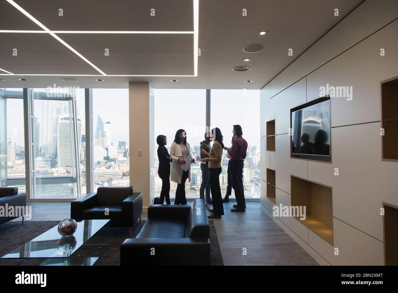 Business people talking in modern highrise office lobby Stock Photo - Alamy