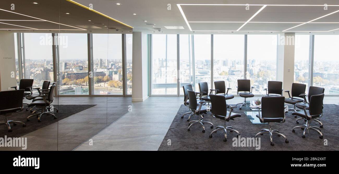 Chairs in a circle in modern highrise conference room Stock Photo - Alamy