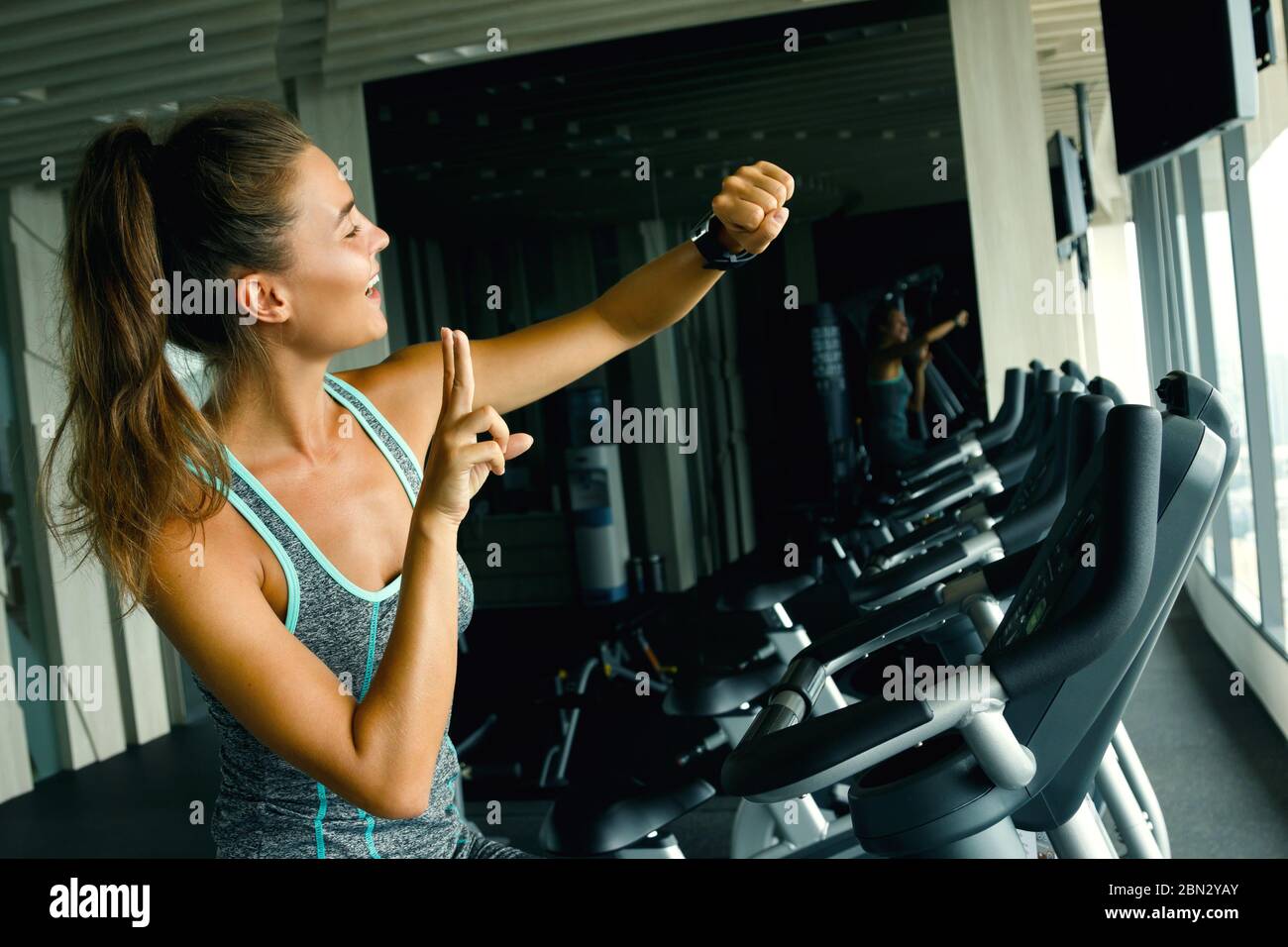 Woman is using smart watch during her workout in the gym Stock Photo ...