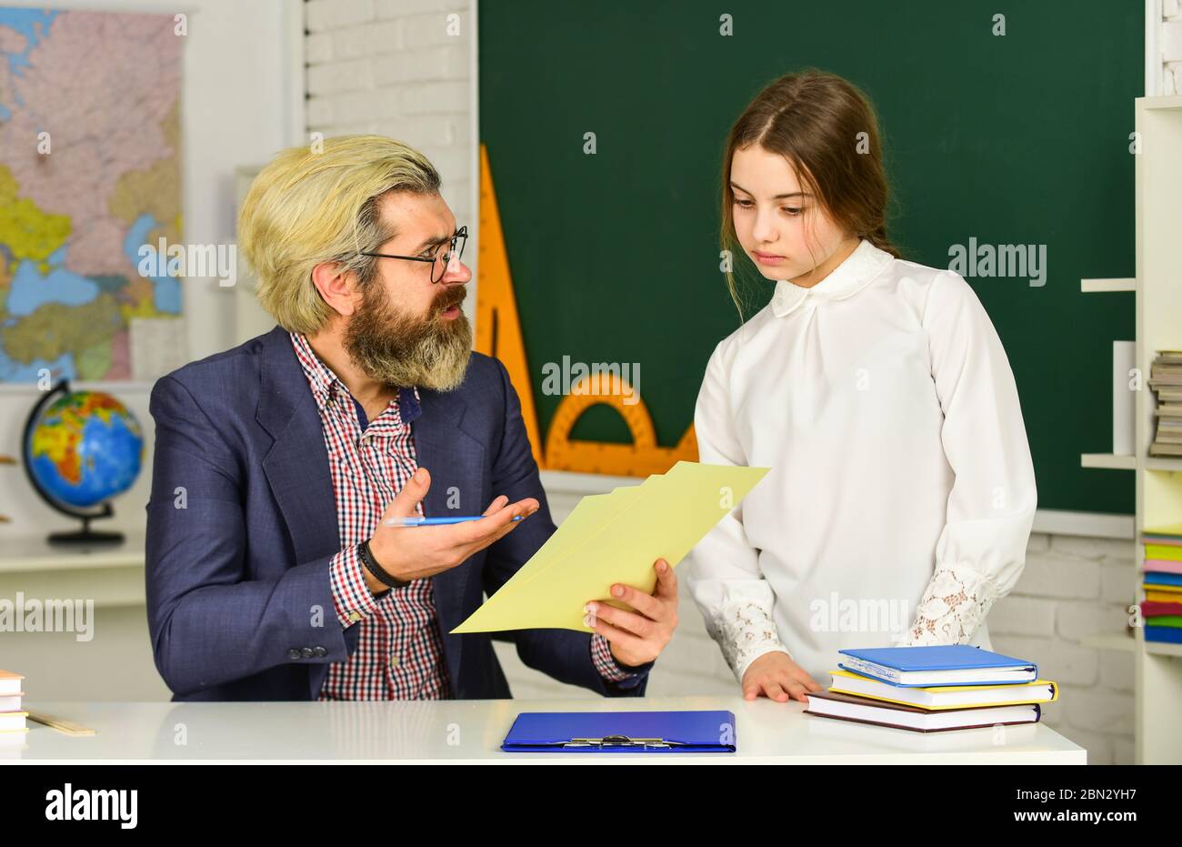 Bearded man teacher in classroom. Teacher checking right answer ...