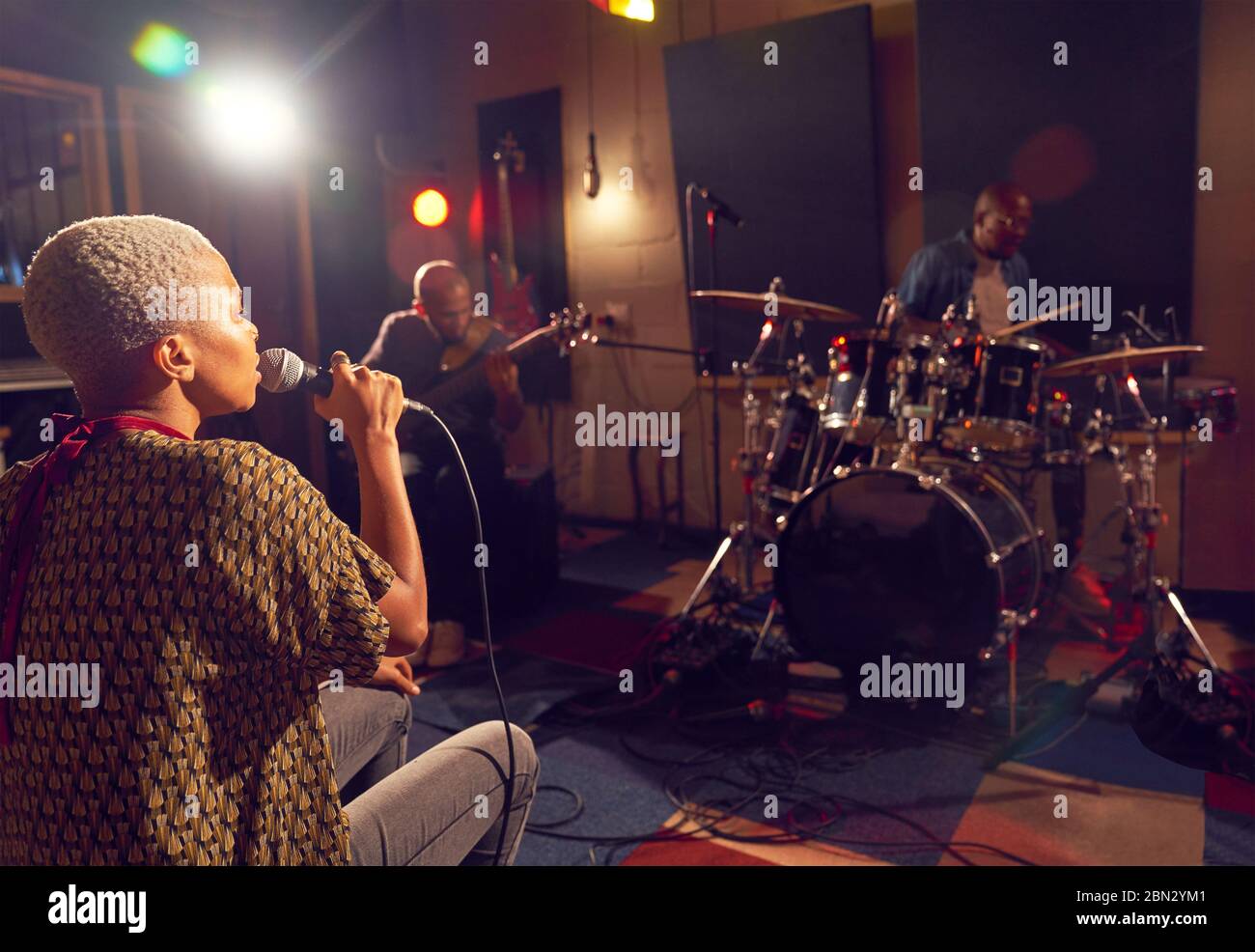 Musicians performing in recording studio Stock Photo - Alamy