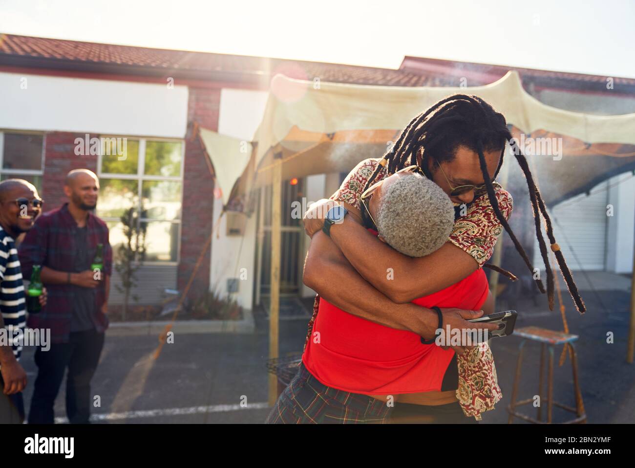 Boyfriend girlfriend hugging friends hi-res stock photography and ...