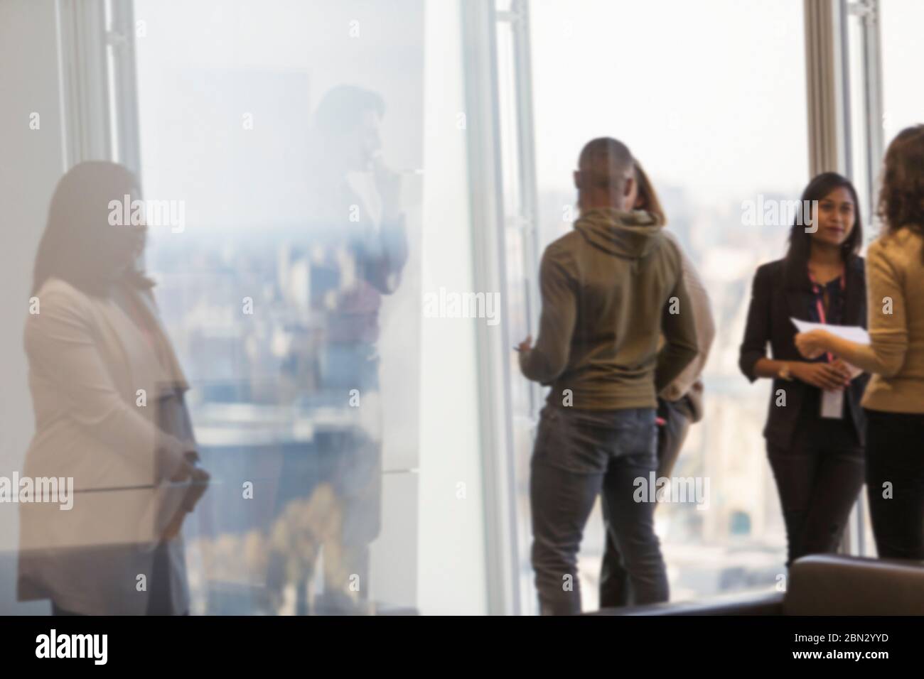 Business people talking at office window Stock Photo - Alamy