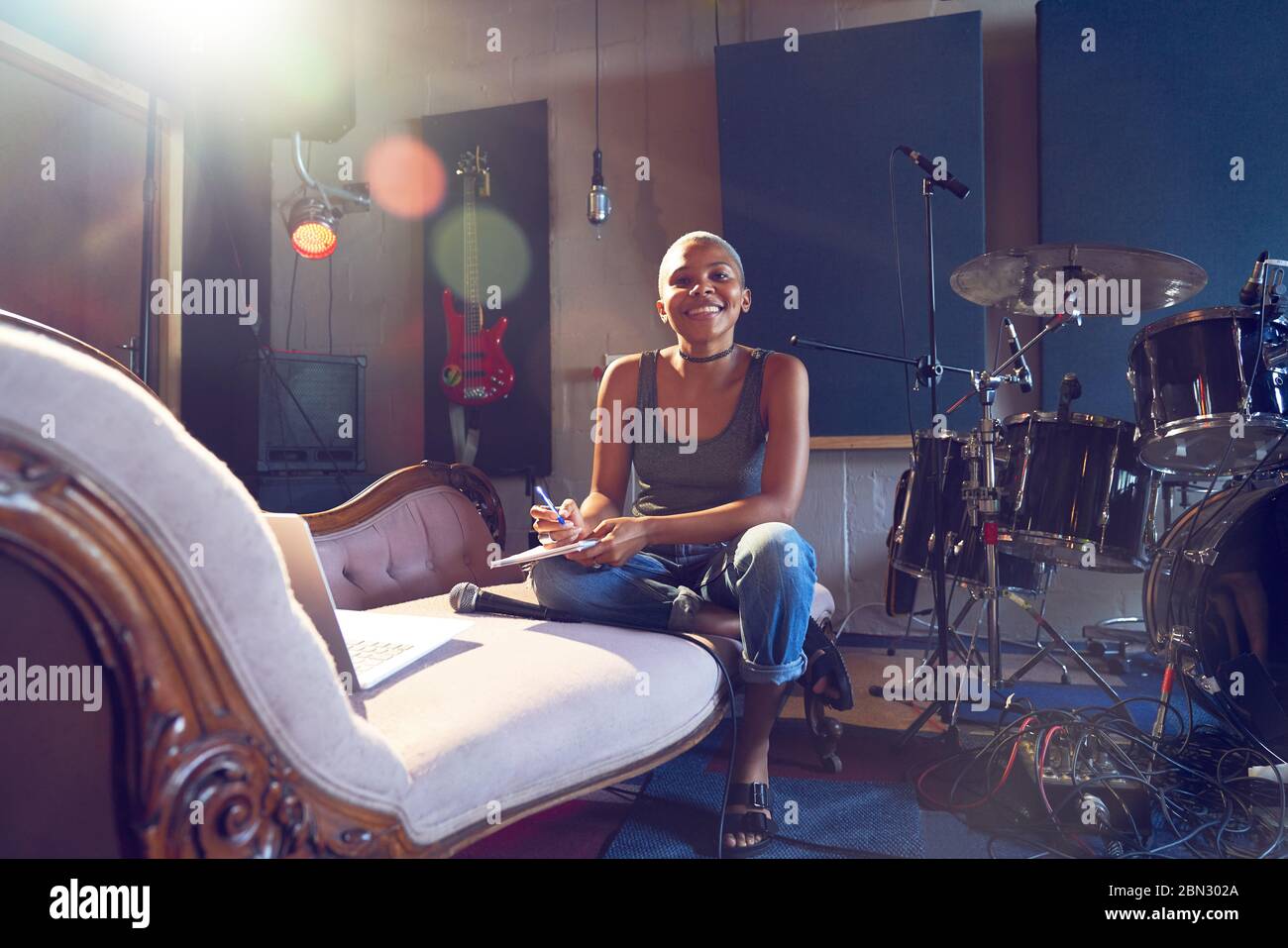 Portrait confident young female musician song writing in studio Stock ...
