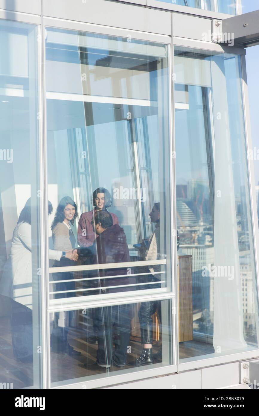 Business people talking at sunny office window Stock Photo - Alamy