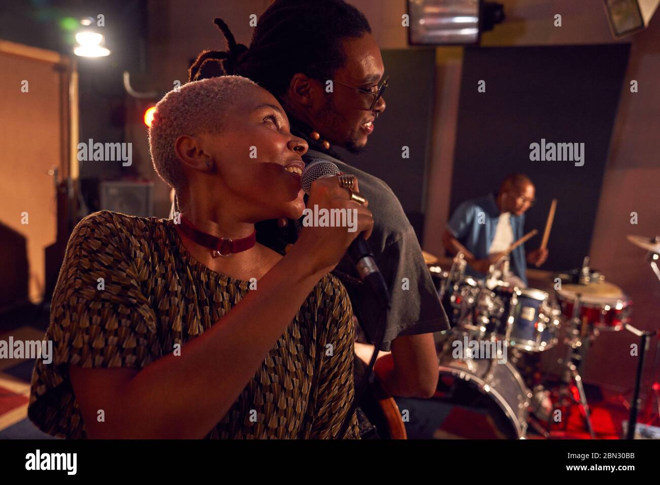 Musicians singing and practicing in recording studio Stock Photo - Alamy