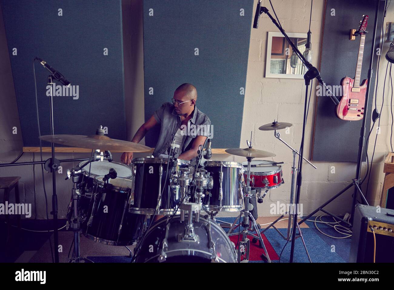 Male drummer practicing in recording studio Stock Photo - Alamy