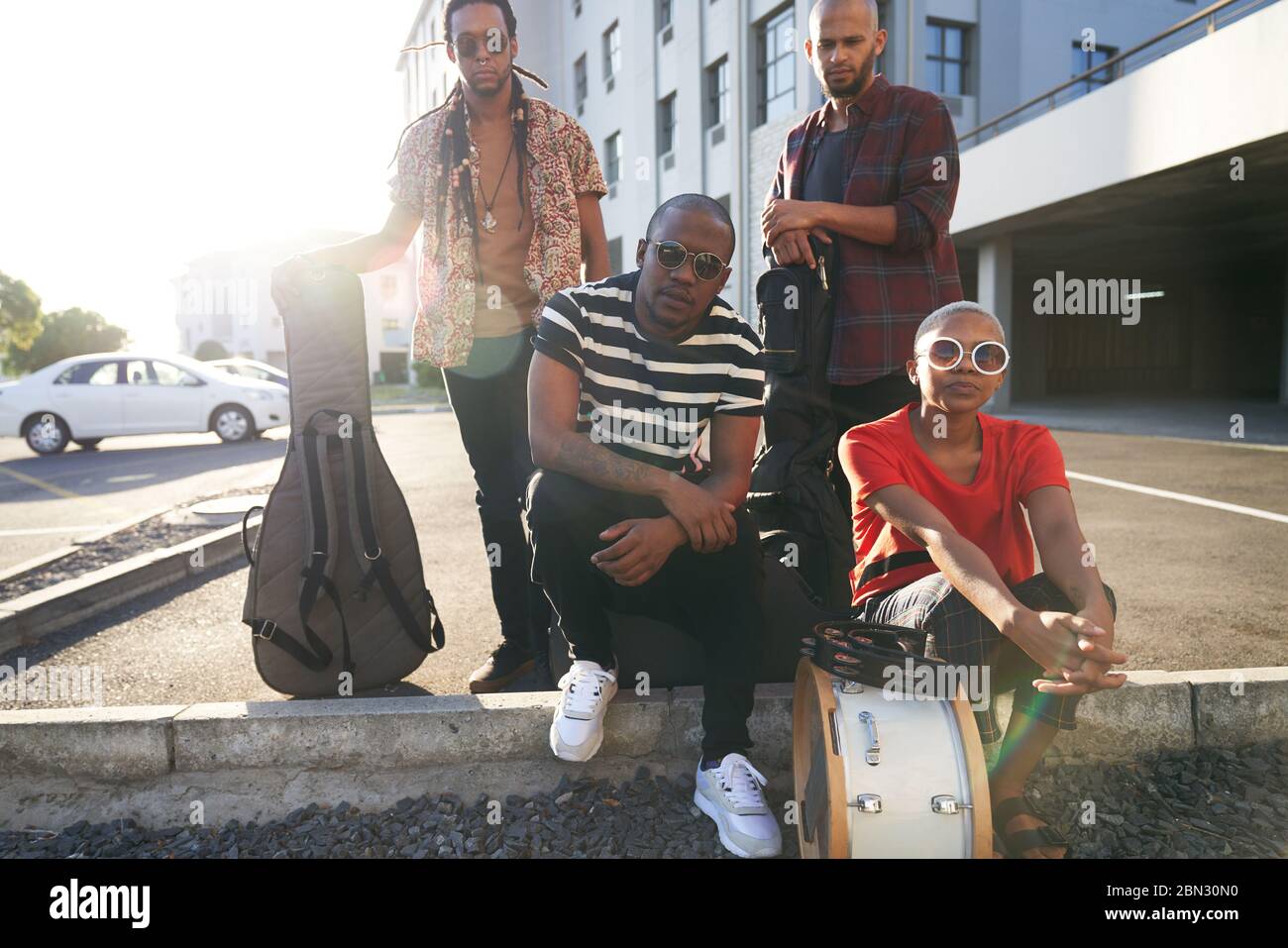 Portrait confident cool musicians in sunny parking lot Stock Photo - Alamy