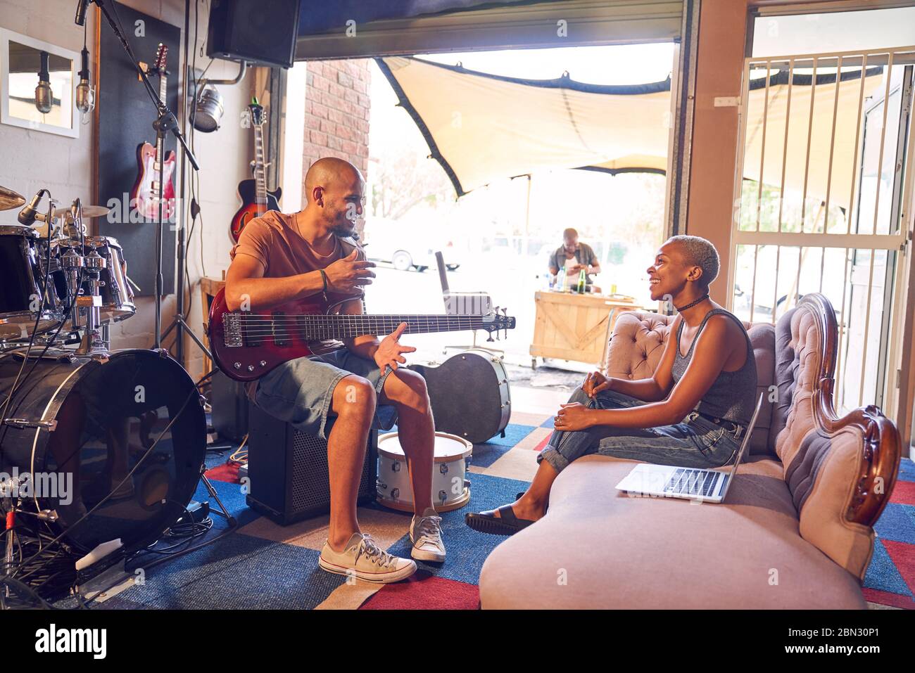 Musicians talking and practicing in garage recording studio Stock Photo ...