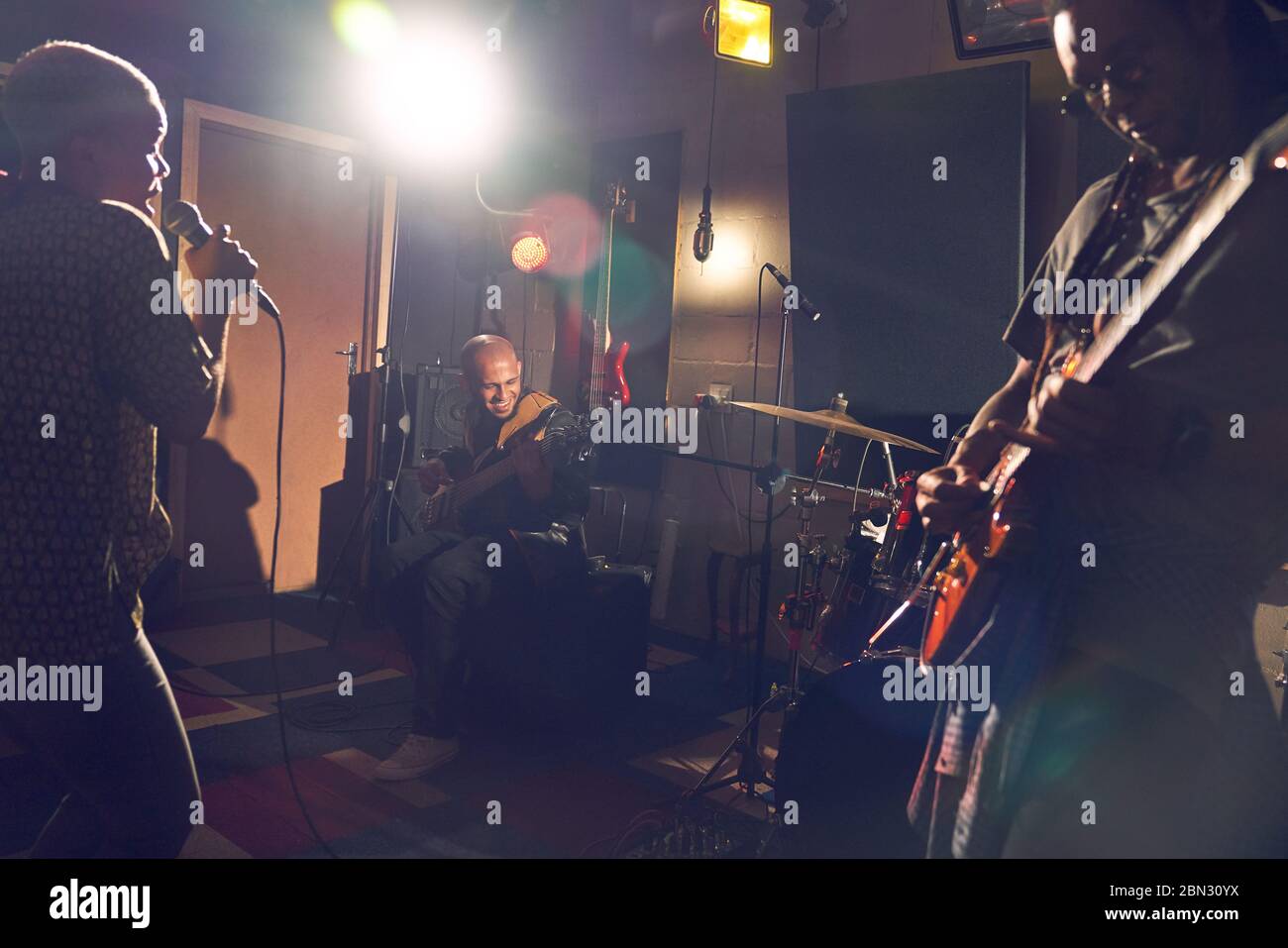 Musicians practicing in recording studio Stock Photo - Alamy