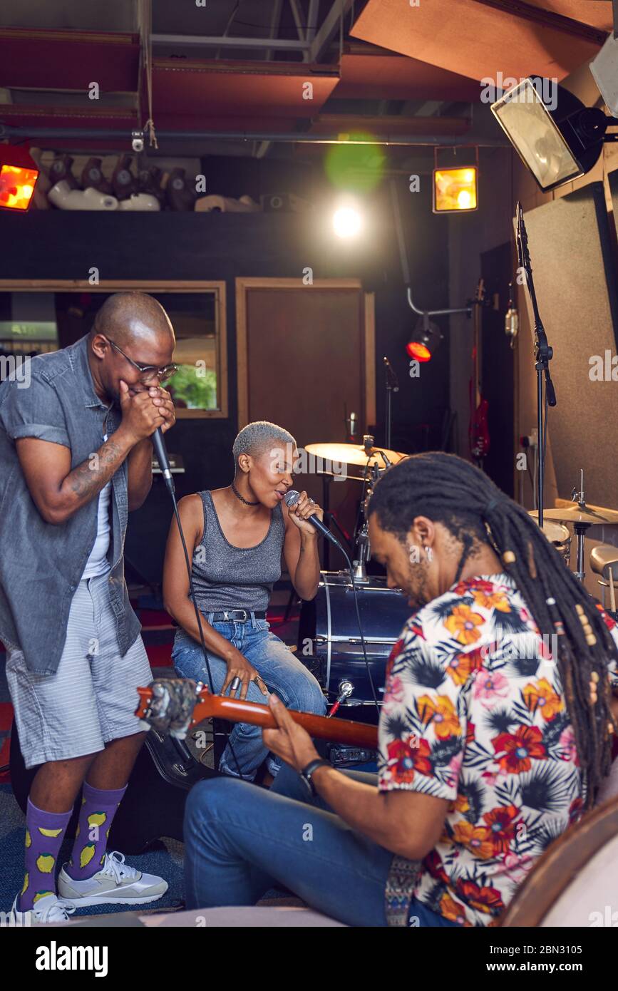 Musicians practicing in recording studio Stock Photo - Alamy