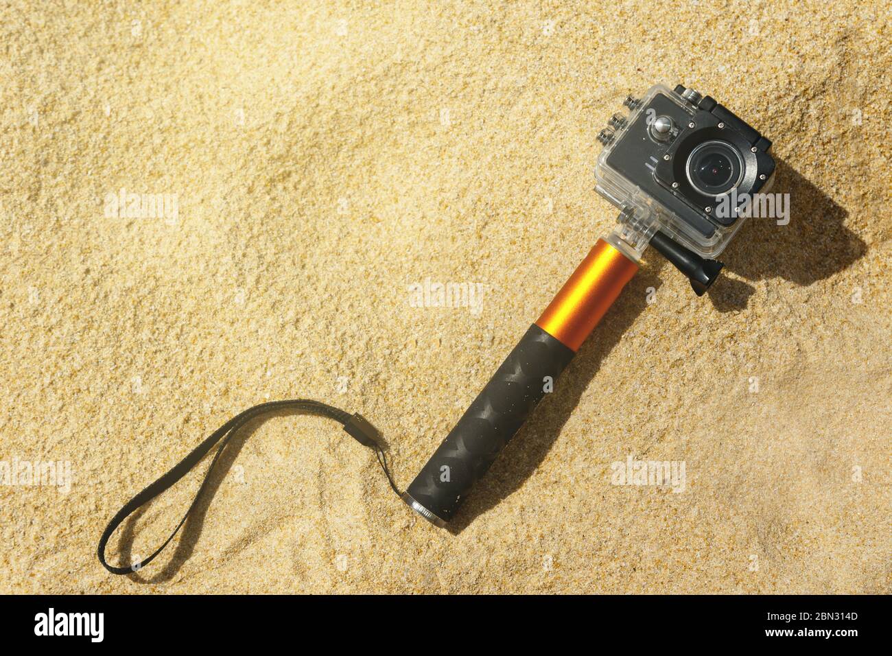 Action camera in waterproof case with monopod on the beach Stock Photo ...