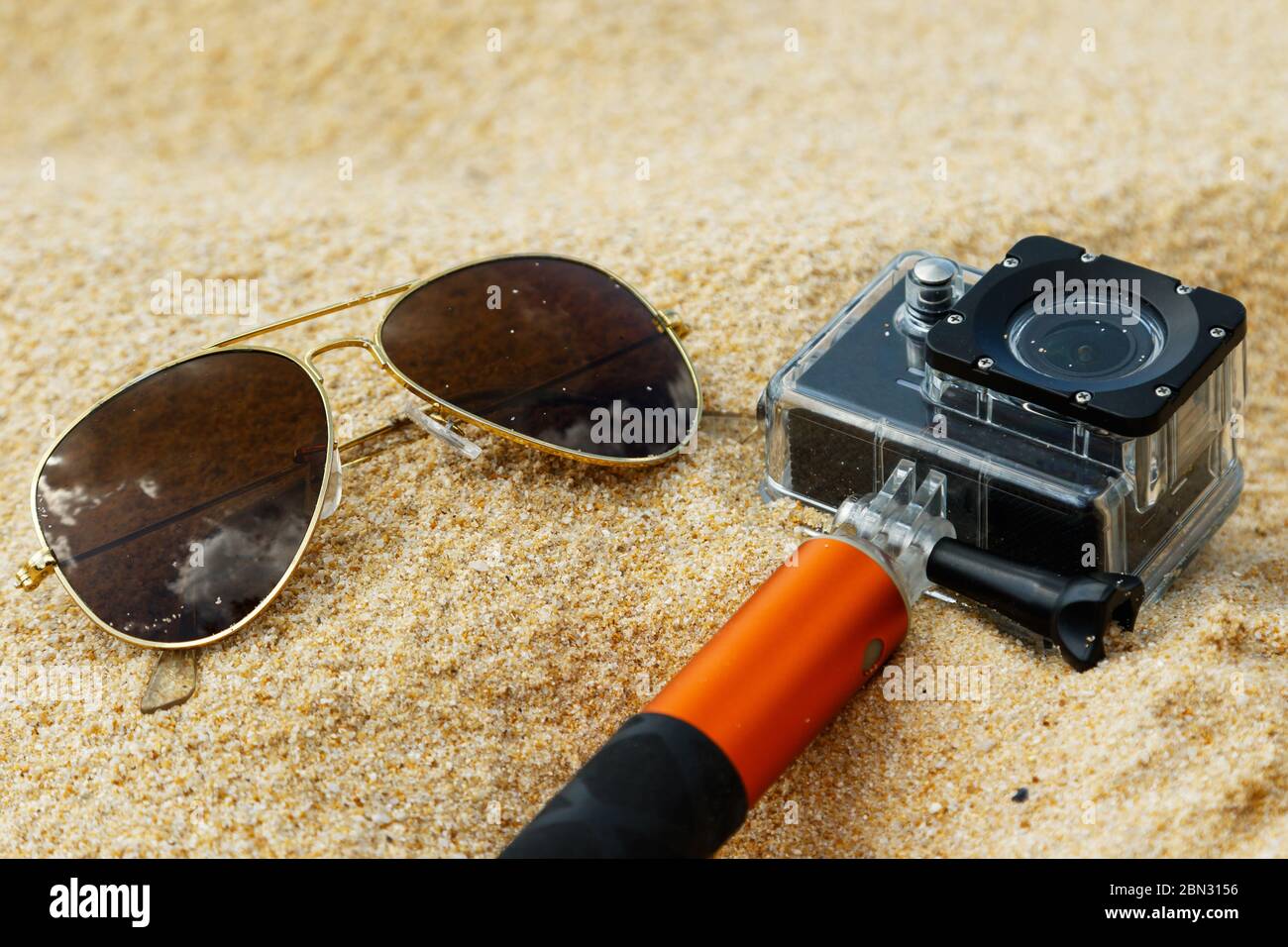 Sunglasses and action-cam on the sand Stock Photo - Alamy
