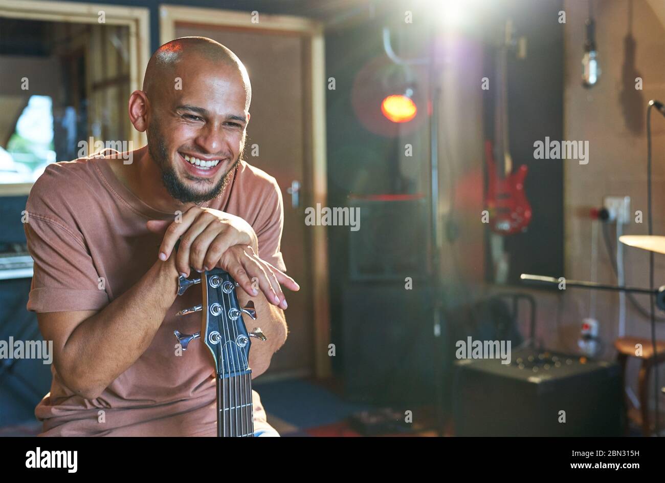 Happy male musician in recording studio Stock Photo - Alamy