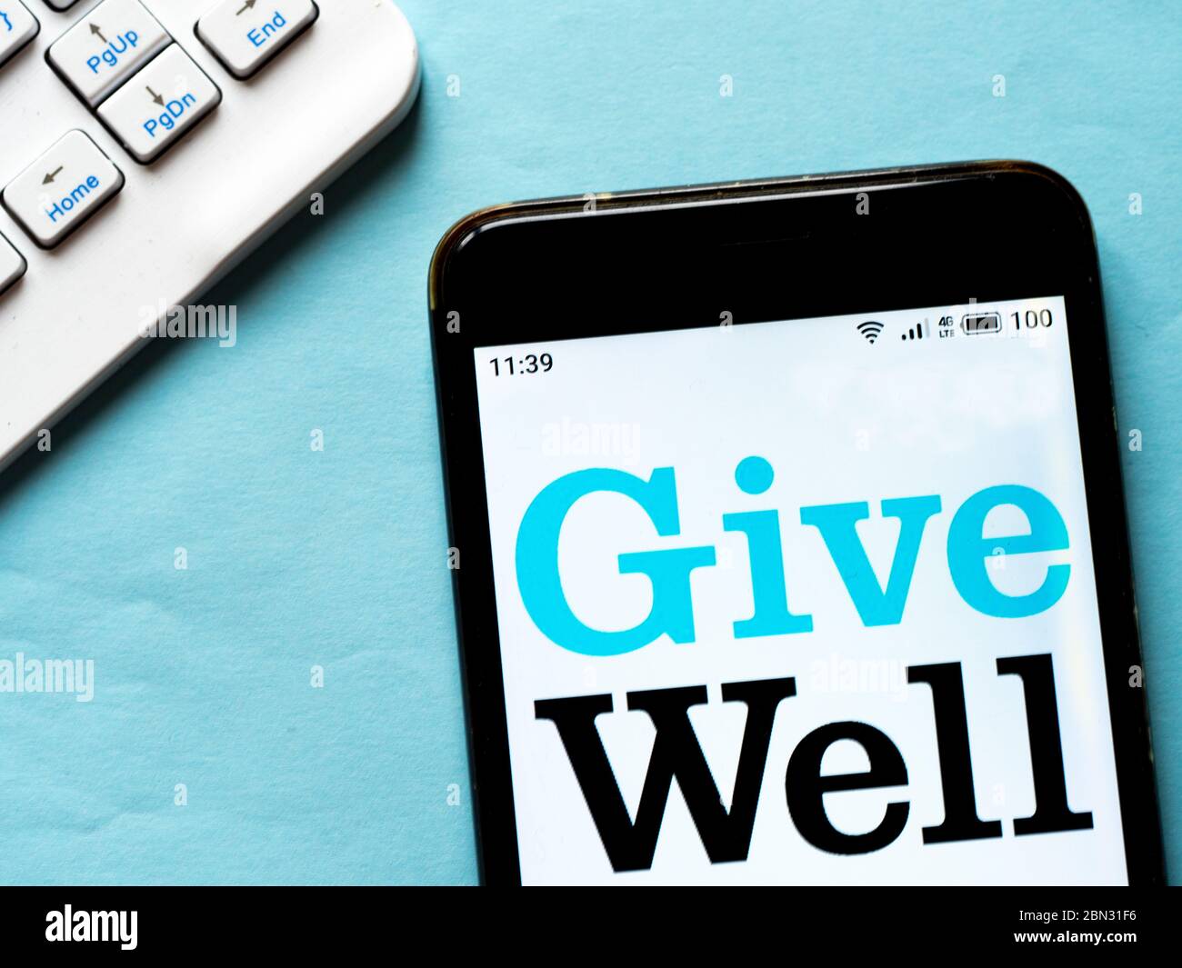 In this photo illustration a GiveWell logo seen displayed on a ...