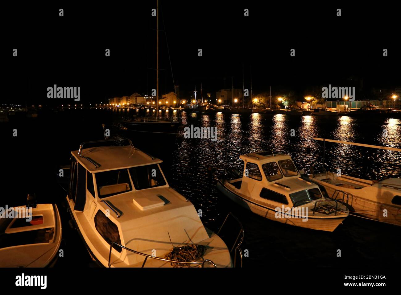 Fishing boats in the port at night Stock Photo - Alamy