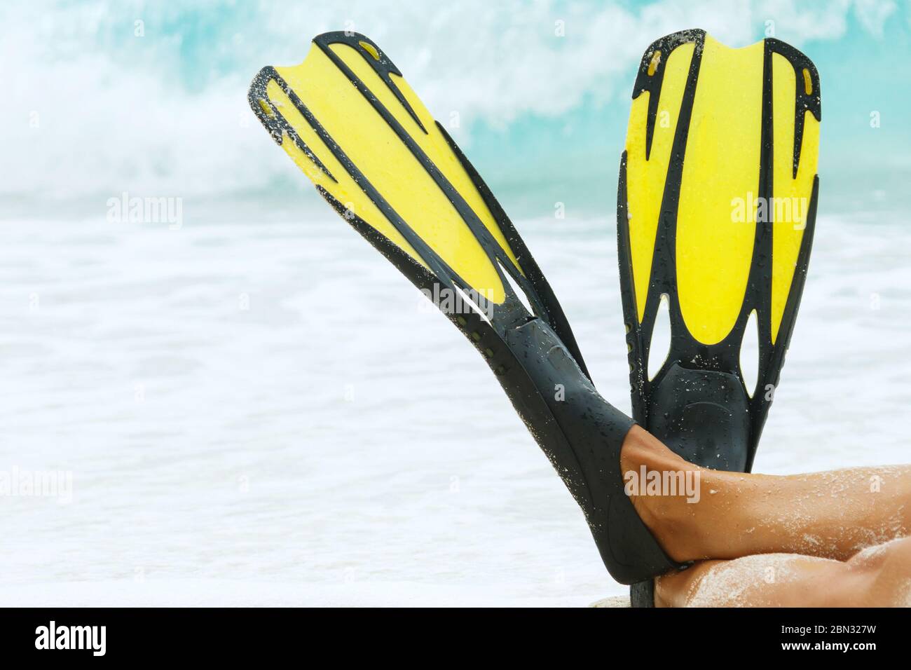 Female legs in flippers on the beach Stock Photo - Alamy