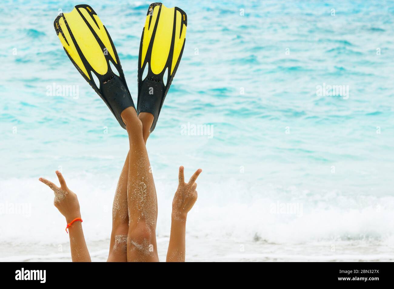 Female legs in flippers on the beach Stock Photo - Alamy