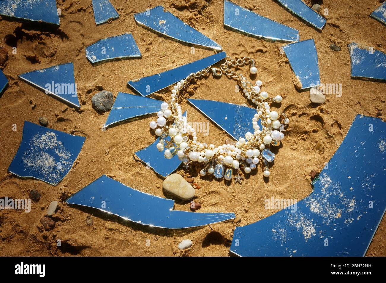 Beautiful necklace with pearls lying on mirror shards Stock Photo - Alamy