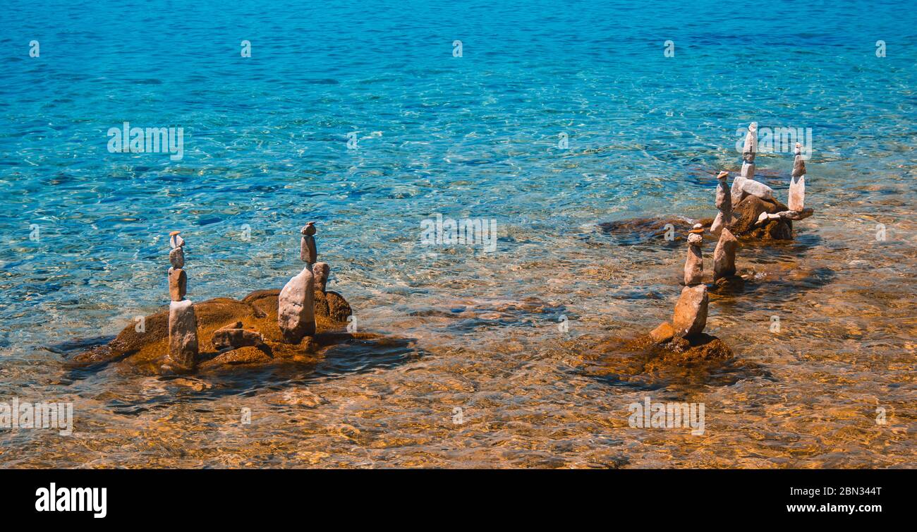 Piled rocks in shallow water. Stacked stones at Rab town coastline. Rab ...