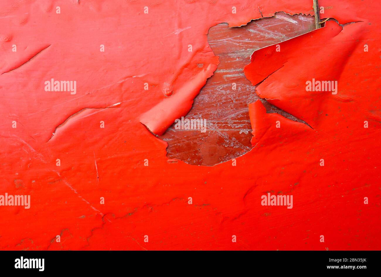 Peeling red paint on fiberglass canoe bottom Stock Photo - Alamy