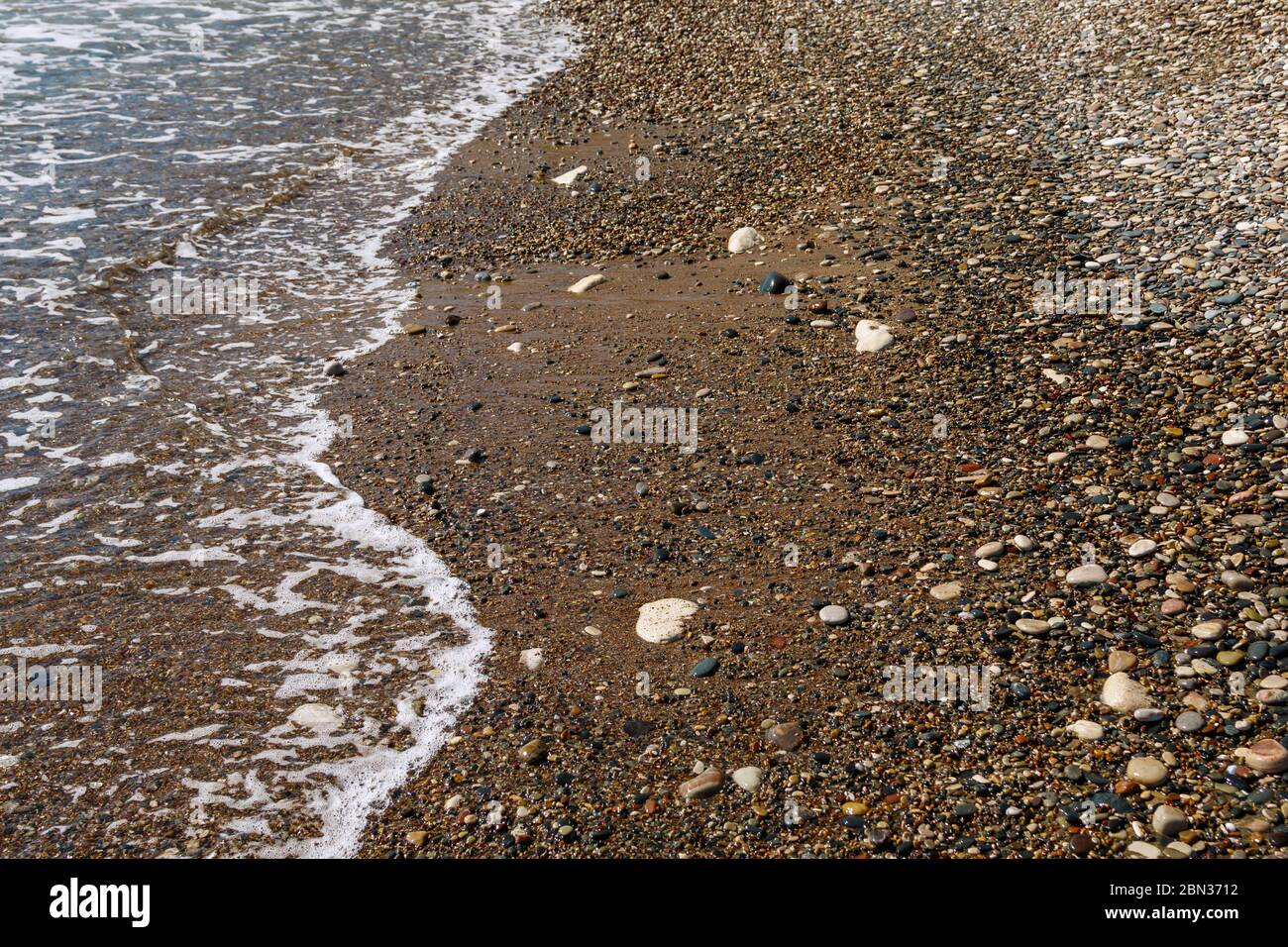 Smooth round pebble stones on the beach Stock Photo - Alamy