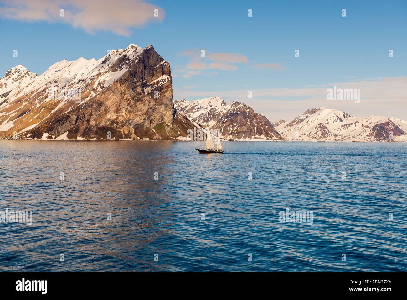 Small sailing vessel with beautiful lighting in Svalbard Stock Photo ...