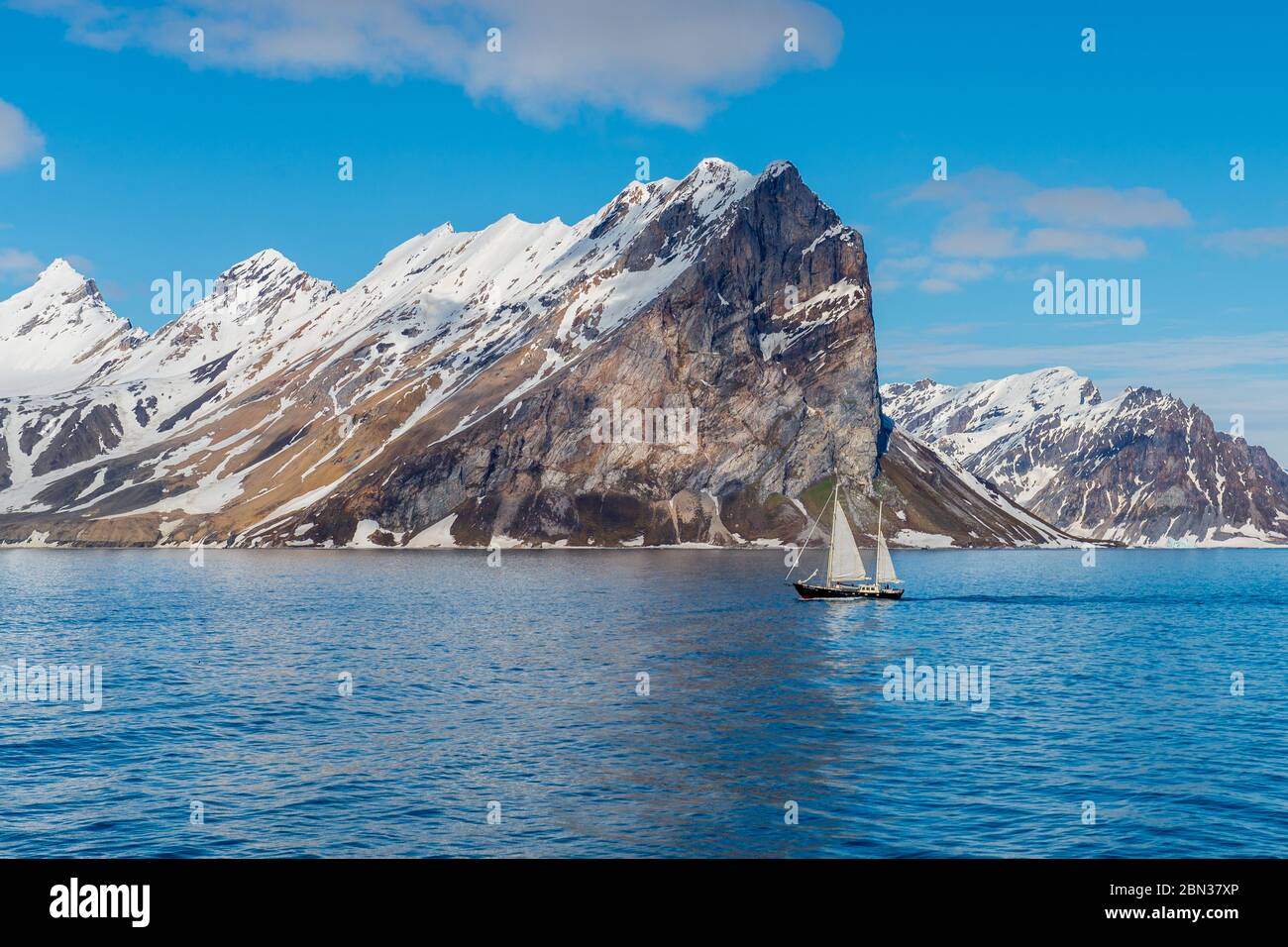 Small sailing vessel with beautiful lighting in Svalbard Stock Photo ...