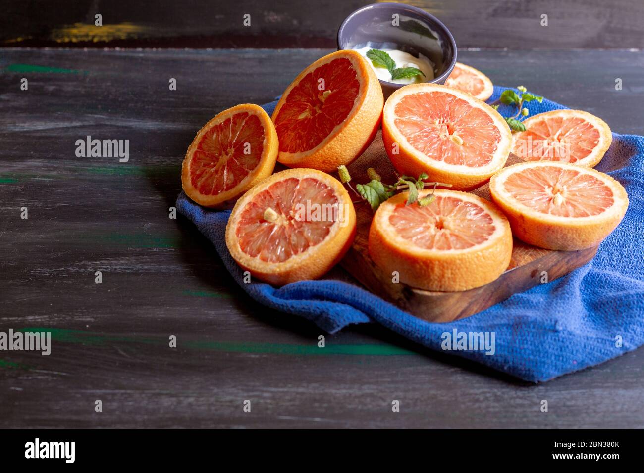 Grapefruits on blue background and decorated plate, to make juices or ...