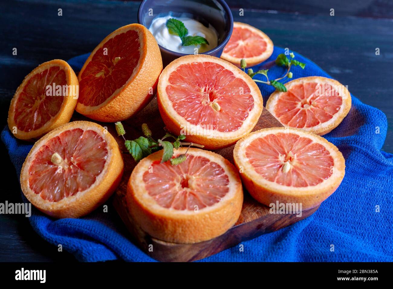 Grapefruits on blue background and decorated plate, to make juices or ...