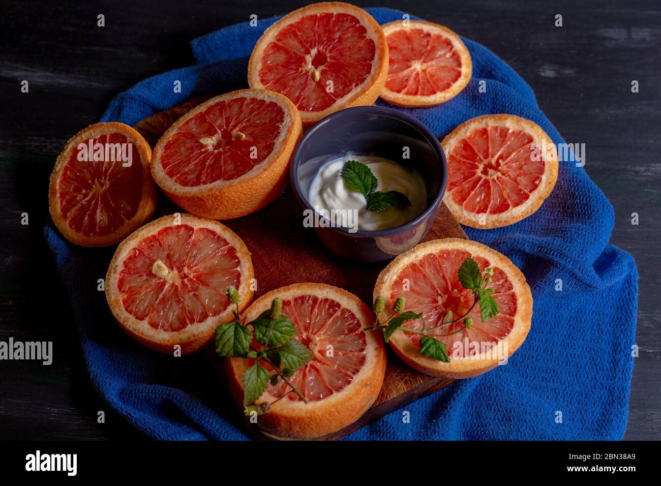 Grapefruits on blue background and decorated plate, to make juices or ...